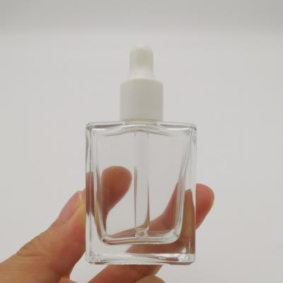 Cina Bottiglie di vetro cosmetiche trasparenti della lozione del quadrato con il contagoccia 1oz 2oz in vendita